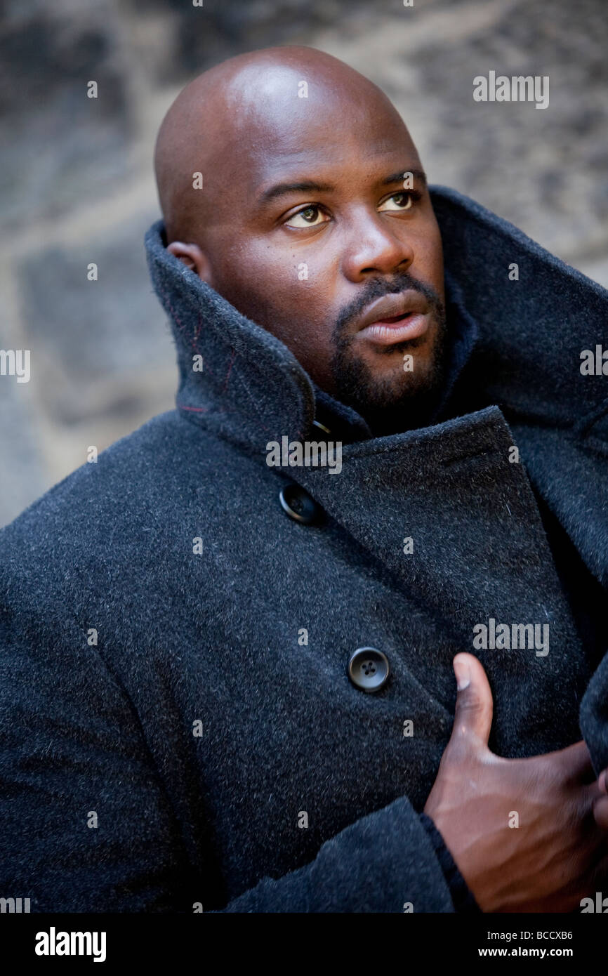 Male model in a black winter coat Stock Photo - Alamy
