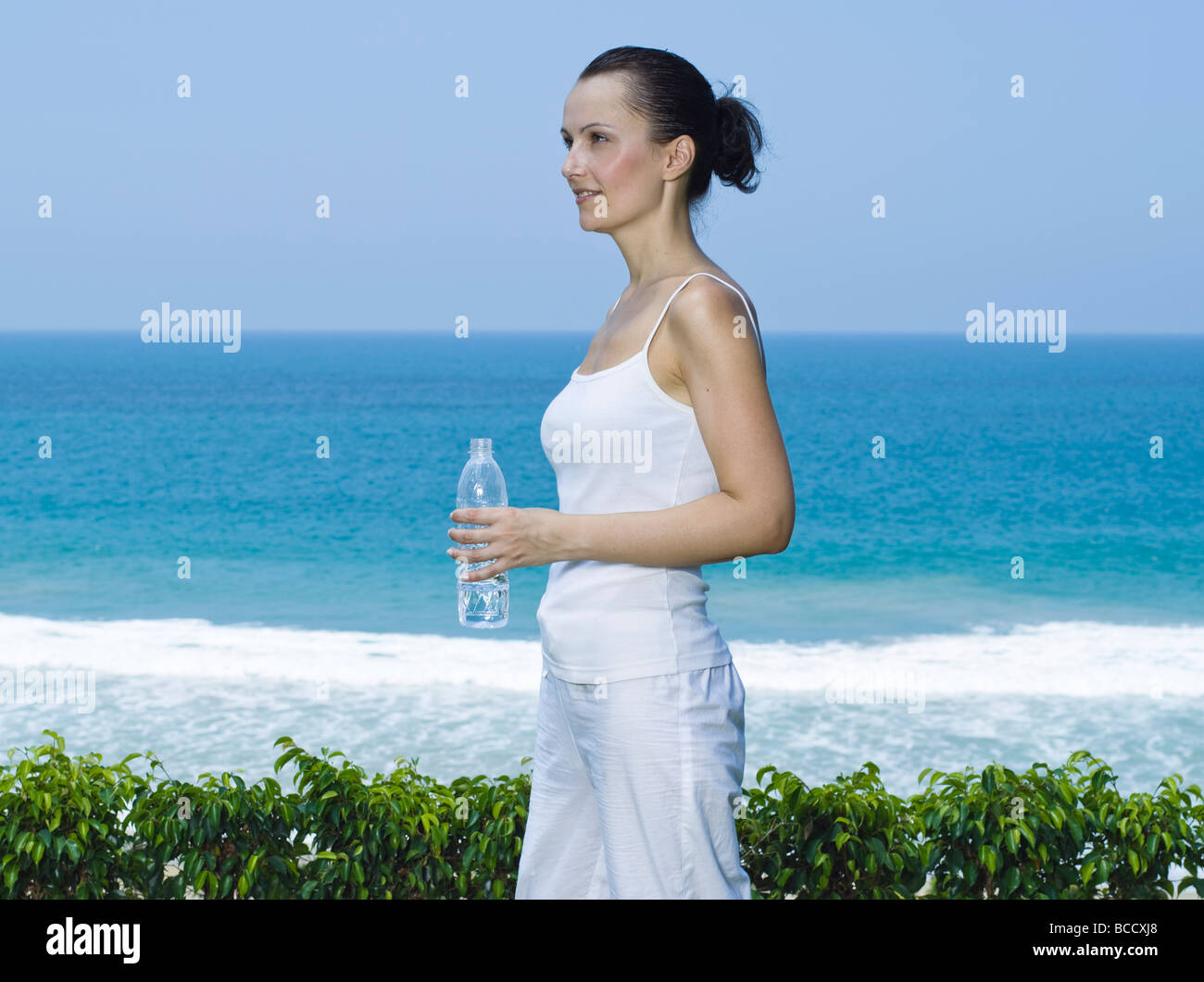 woman caucasian driking water by the seaside Stock Photo - Alamy