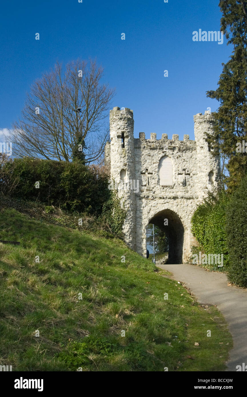 Reigate castle ruins with leading path and green grass against blue sky ...