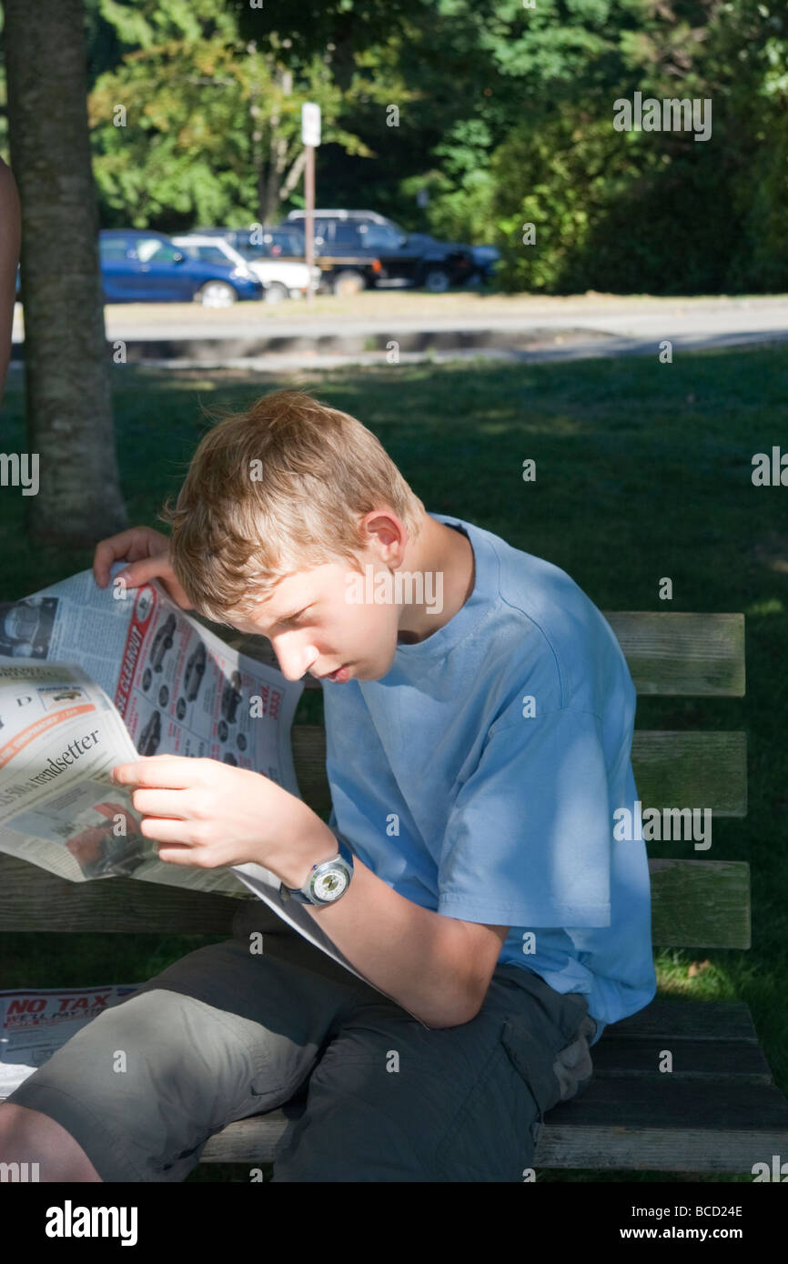 Teenage Boy reading Newspaper Vancouver British Columbia Canada Stock ...