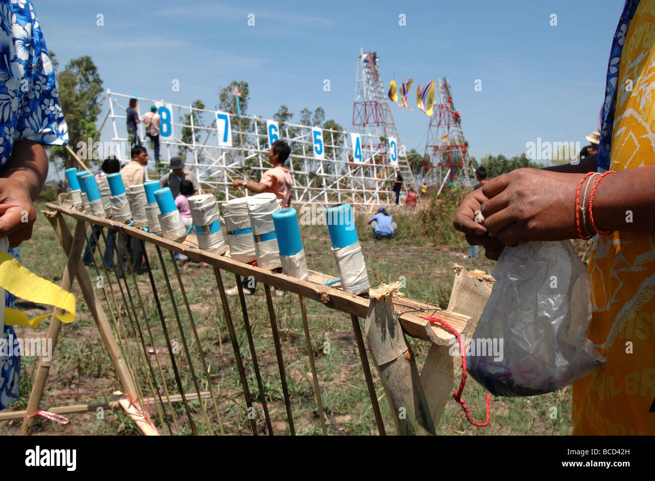 Two men prepare to launch small rockets at the Rocket Festival in ...
