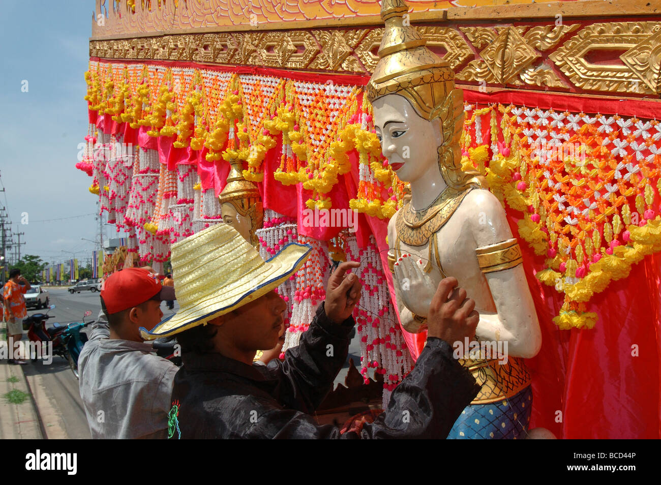 Workers prepare a float for the annual parade at the Rocket Festival in ...