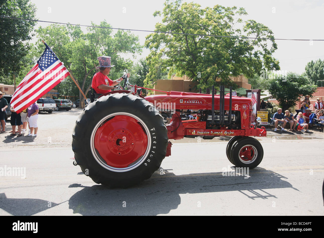 Man driving tractor at 4th of July parade Stock Photo - Alamy