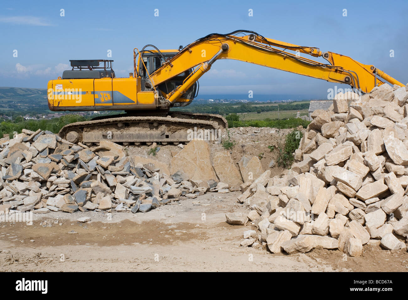 Limestone quarry yard with digger on the Isle of Purbeck, Dorset, UK ...
