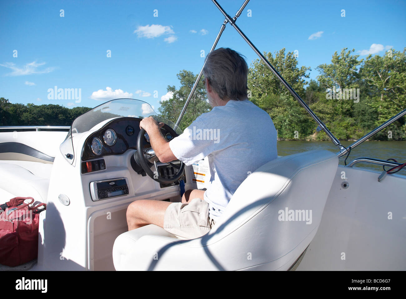 man steering a boat Stock Photo - Alamy