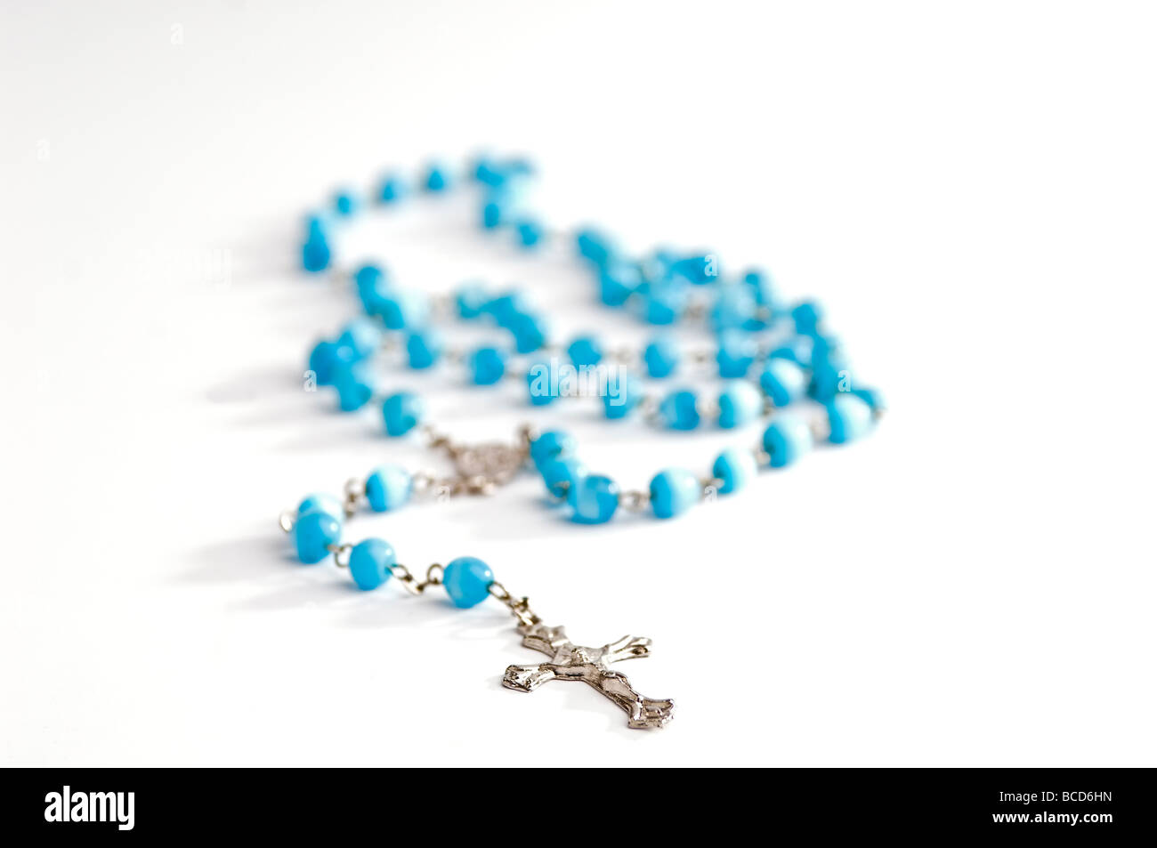 pale blue rosary beads on a white background Stock Photo - Alamy