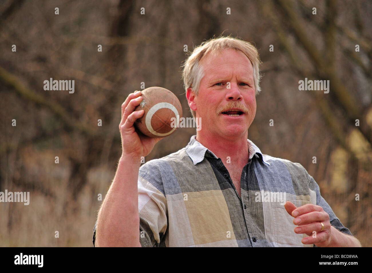senior caucasian male throwing football Stock Photo - Alamy