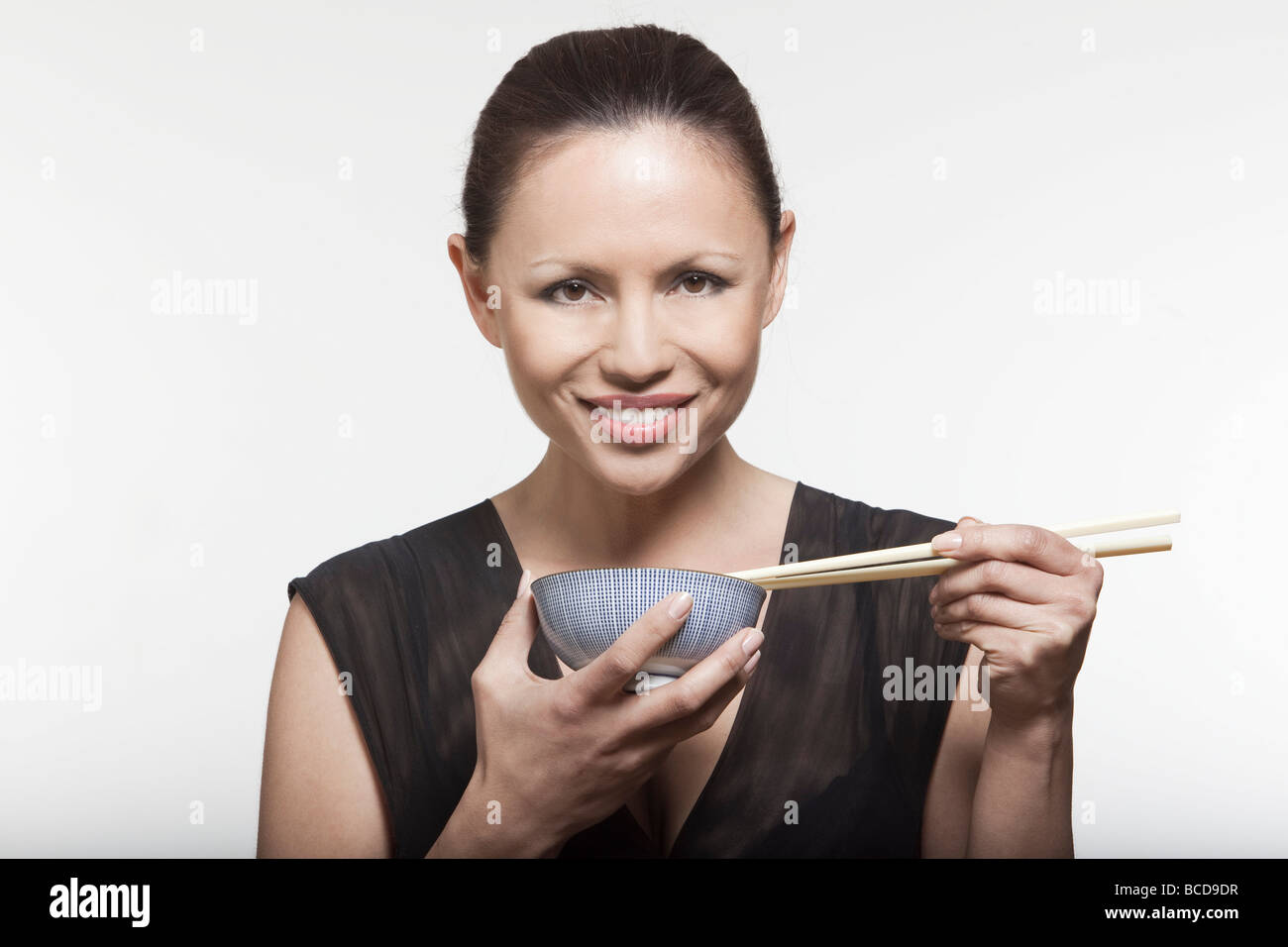 woman eating chopsticks studio bowl studio asian Stock Photo - Alamy