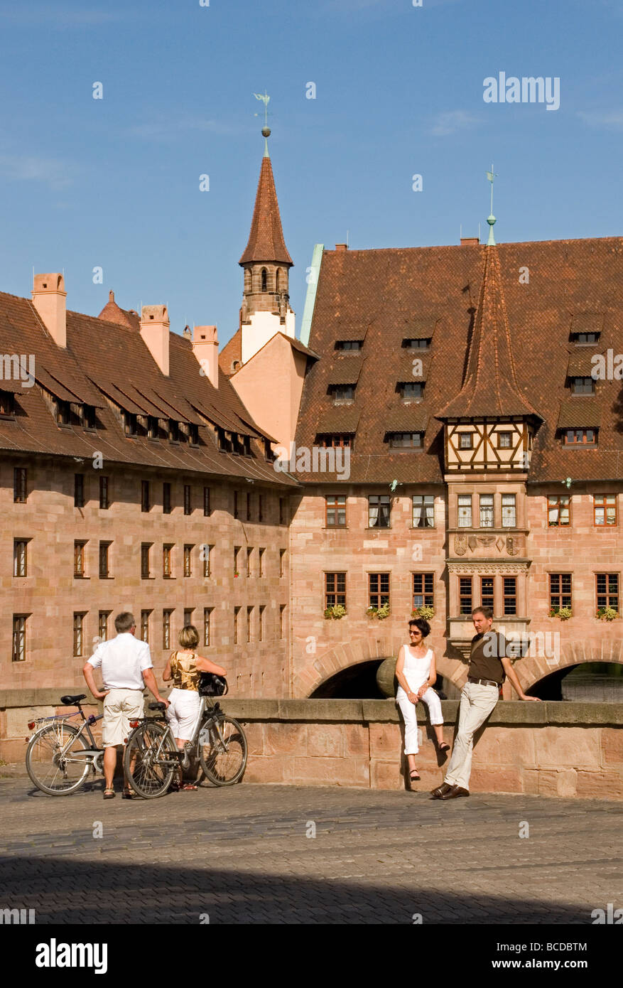 Nuremberg tourist couples on Museumbrueke Bridge over Pegnitz River at ...