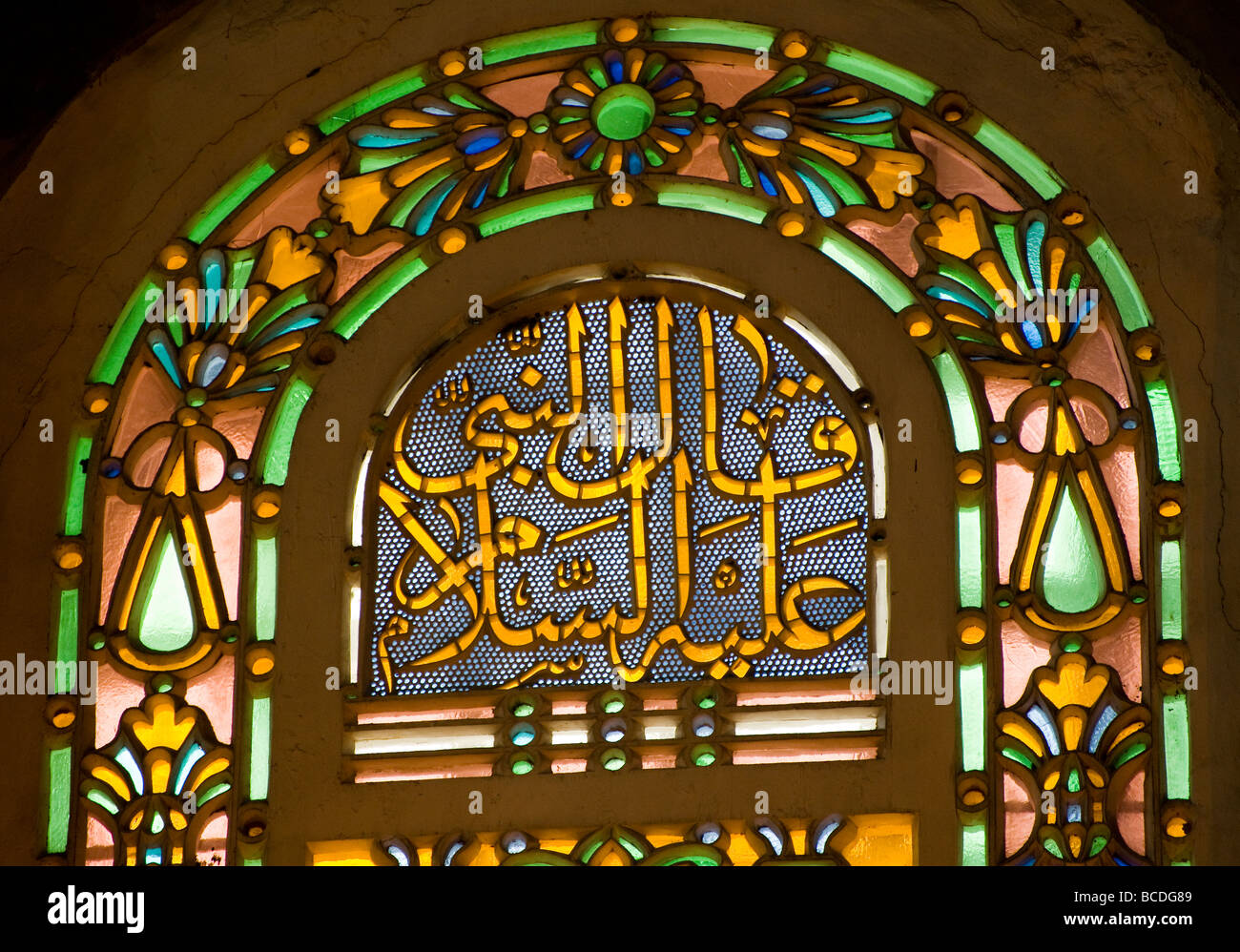 Colourful stained glass windows with Arabic inscription in the apse ...