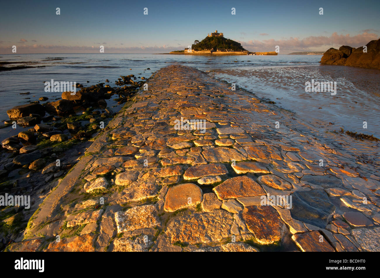 Dawn over the old stone causeway leading to St Michaels Mount on the ...