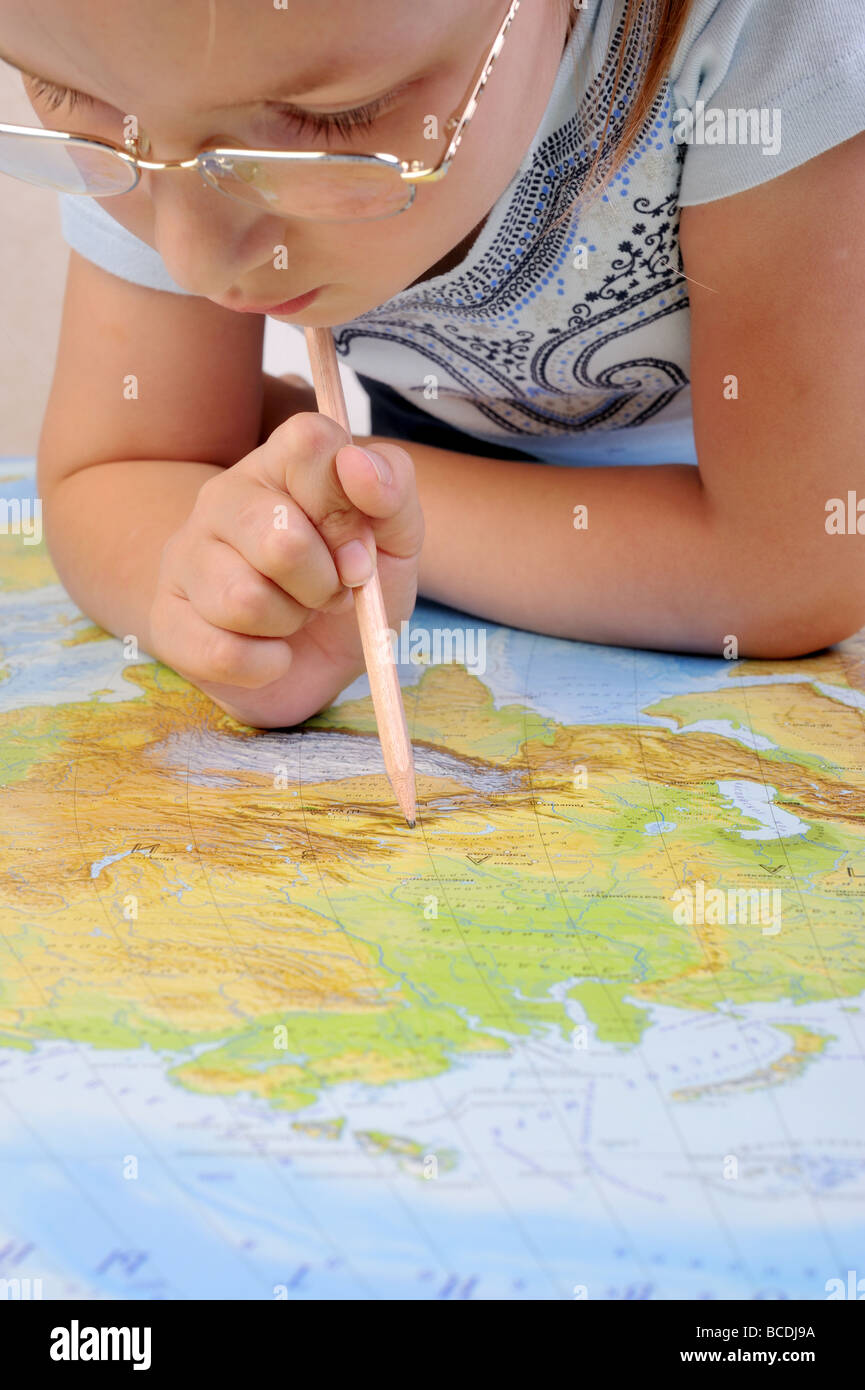 Girl exploring the geographic map of Eurasia Stock Photo - Alamy