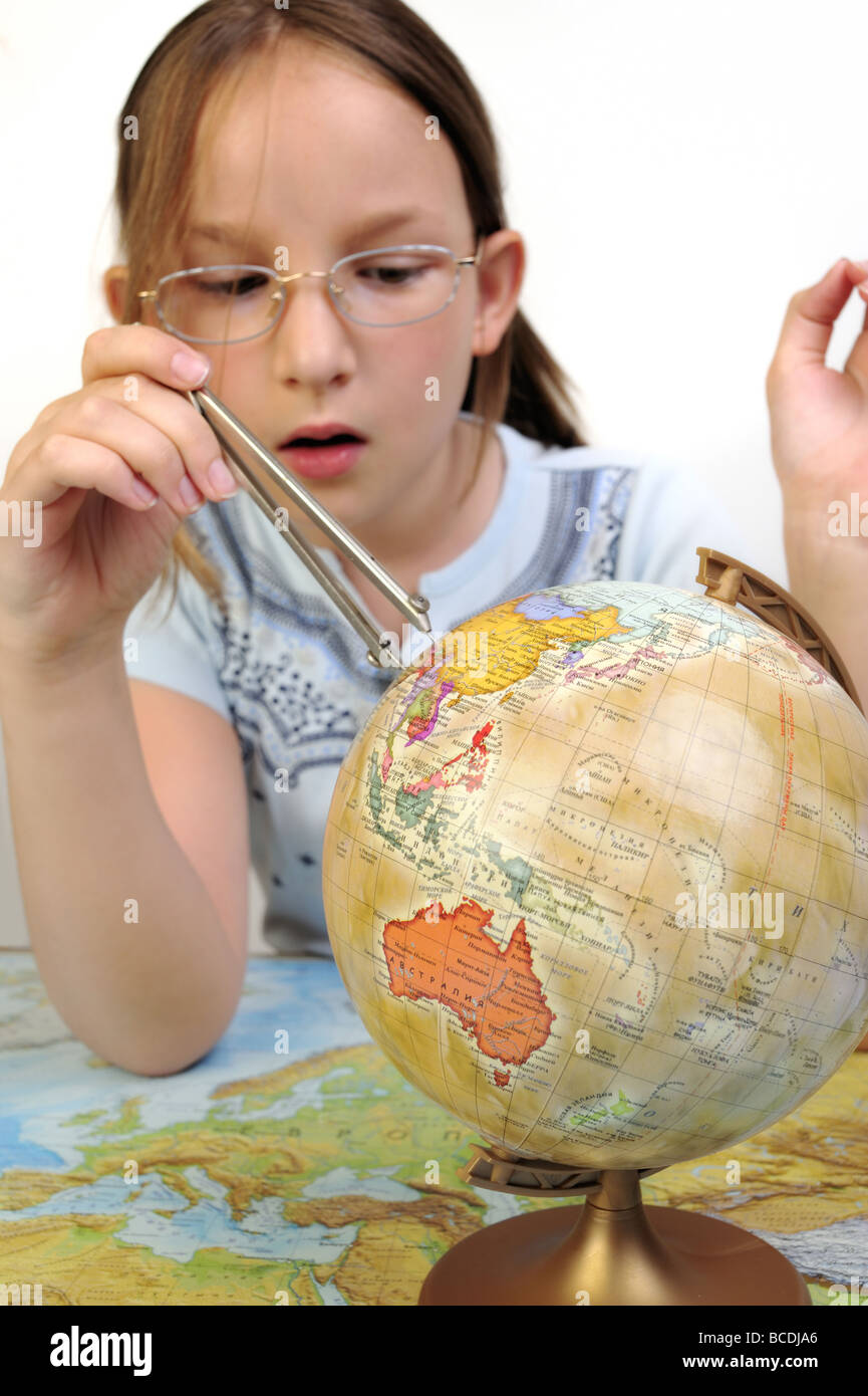 Teenage girl exploring the globe Stock Photo - Alamy