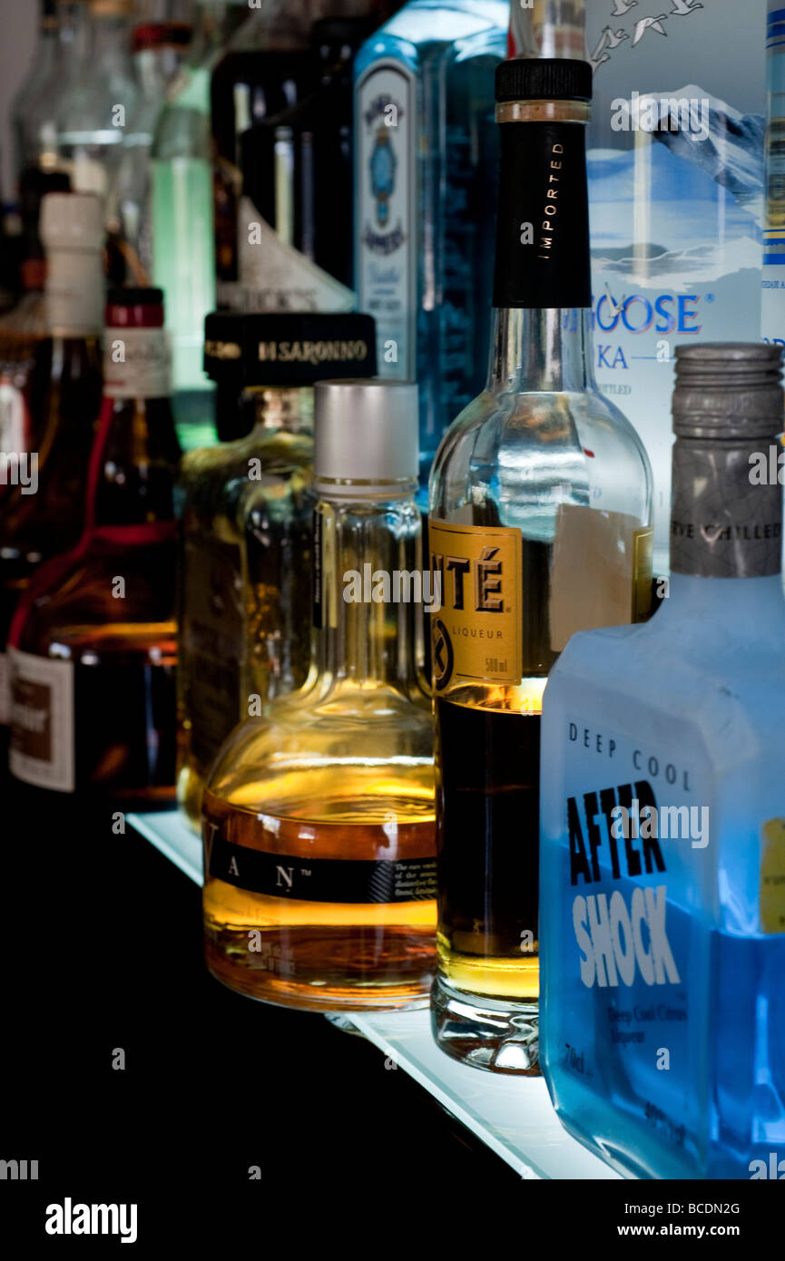 Alcohol bottles on a shelf in a bar Stock Photo - Alamy