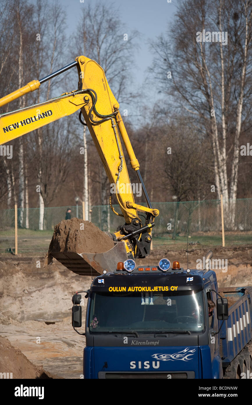 Digger loading dirt to dump truck , Finland Stock Photo - Alamy