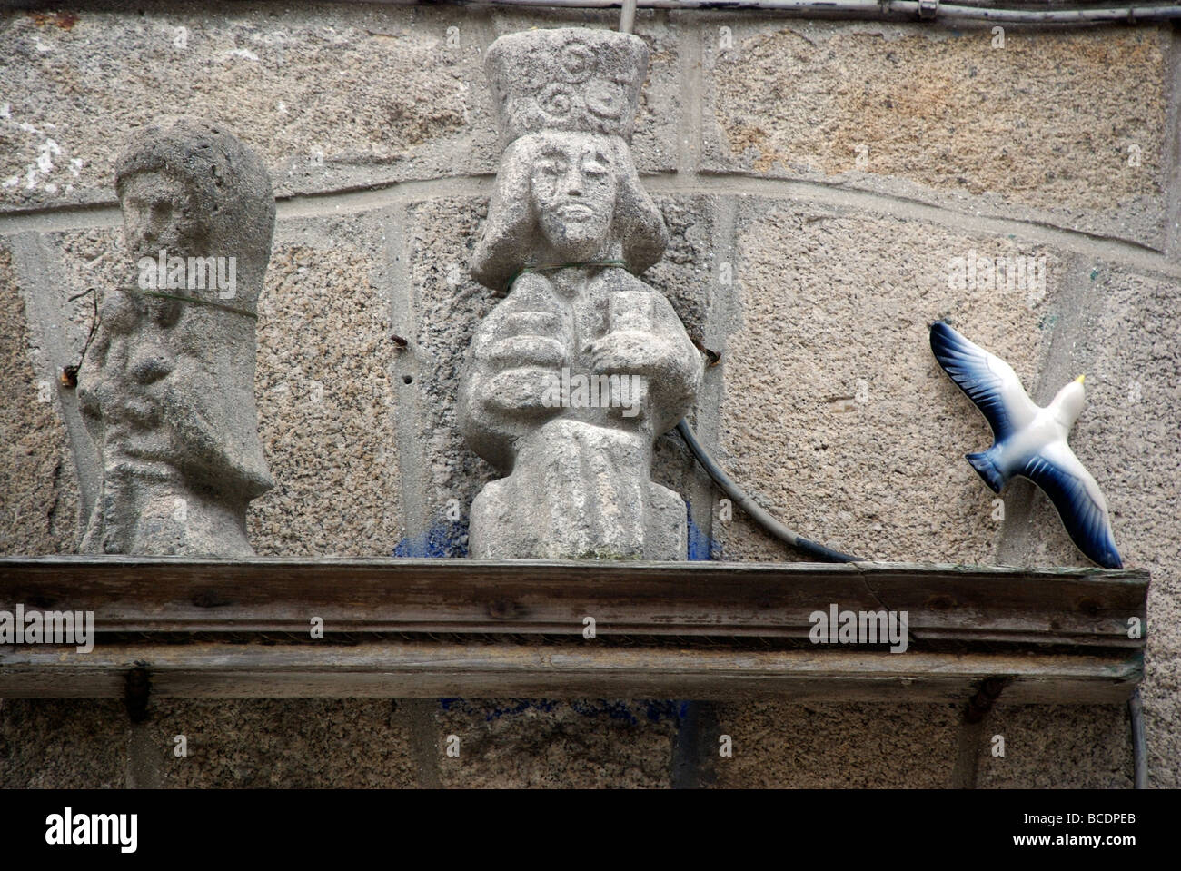 Celtic Triskel symbol on figure and seagull above door, Roscoff ...