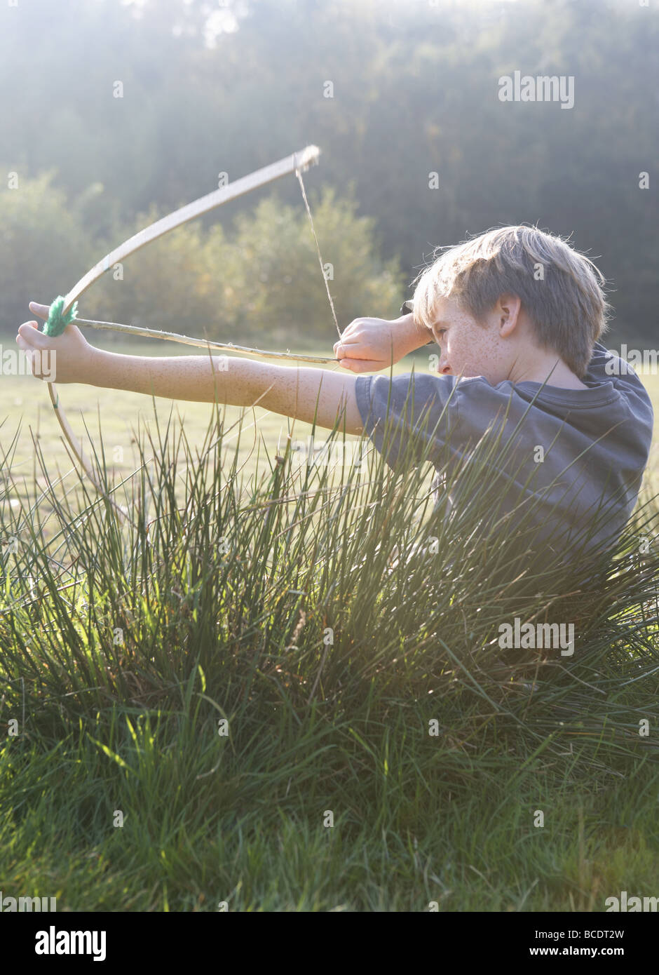 Boy playing with bow and arrow hi-res stock photography and images - Alamy