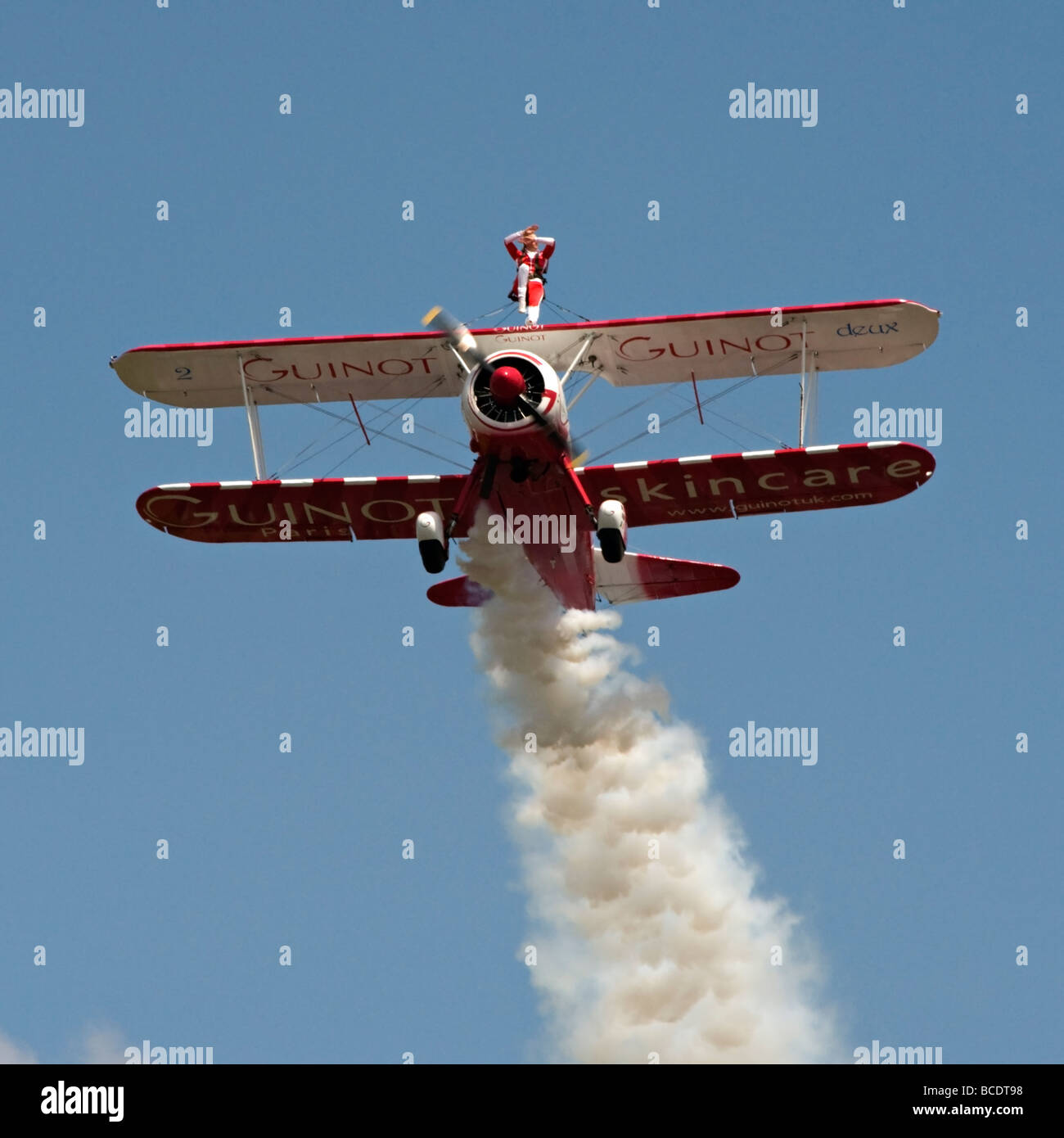 A Boeing Stearman biplane from Team Guinot performs wing walking feats ...