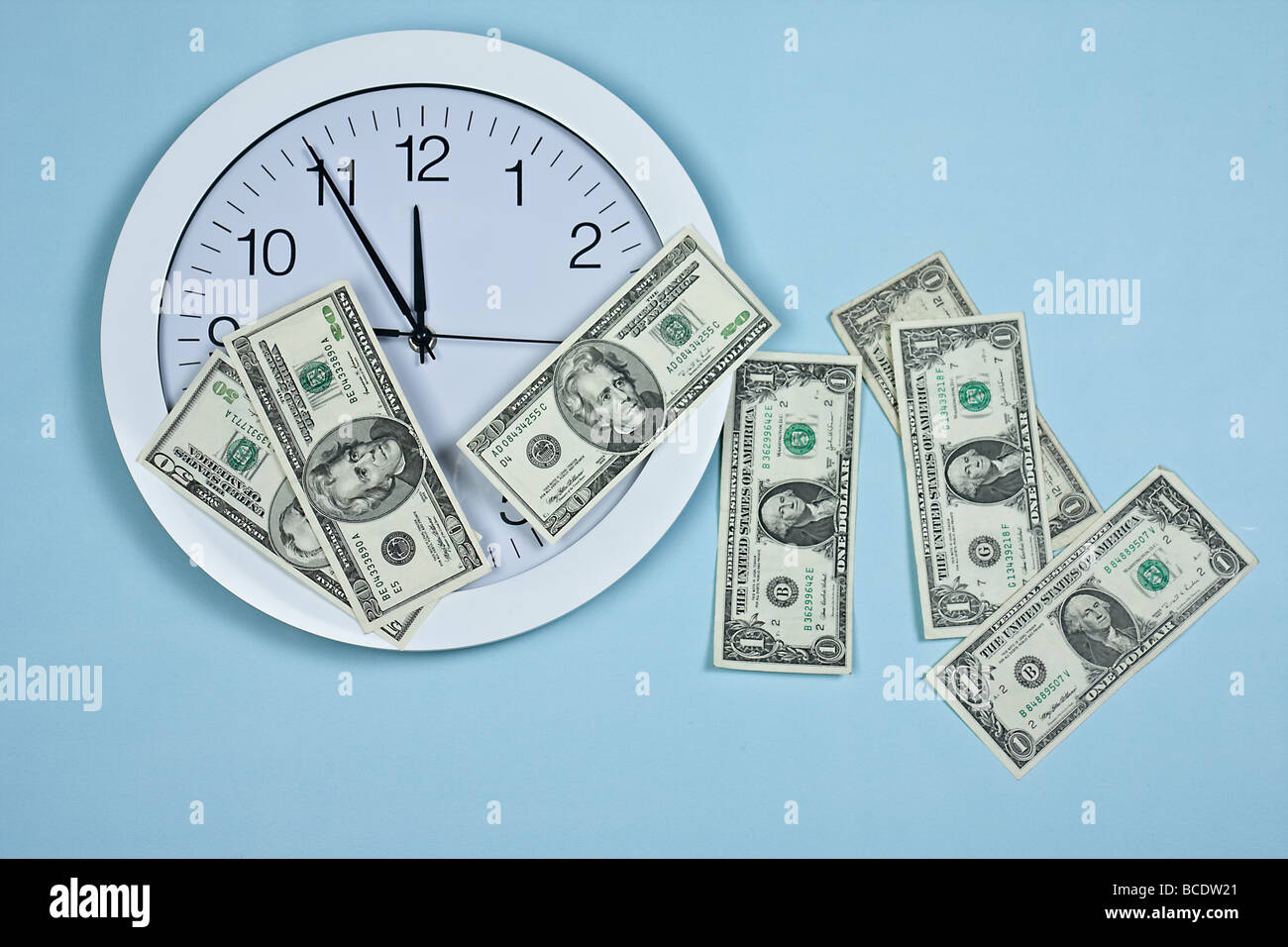 clock and money on blue background Stock Photo - Alamy