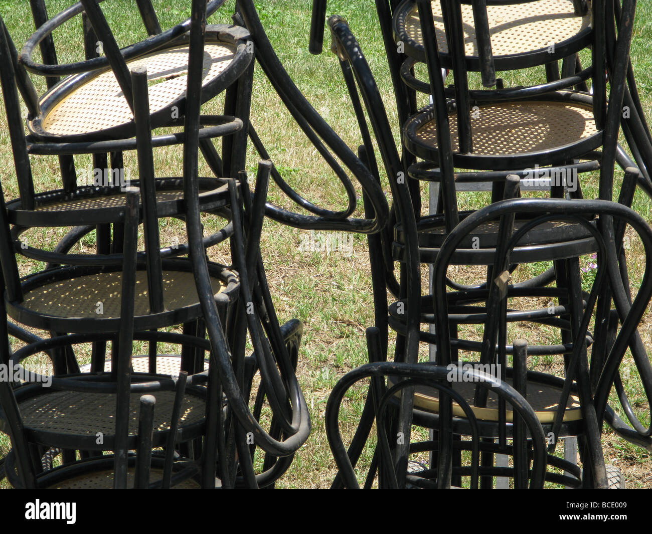 pile of chairs in field in sun outdoors Stock Photo - Alamy