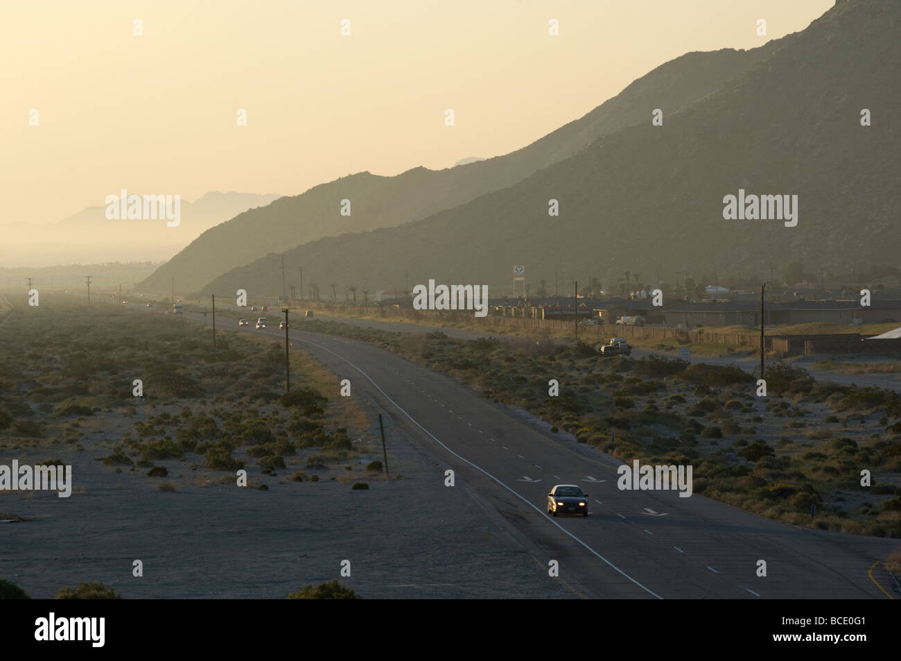 Car on desert highway Stock Photo - Alamy