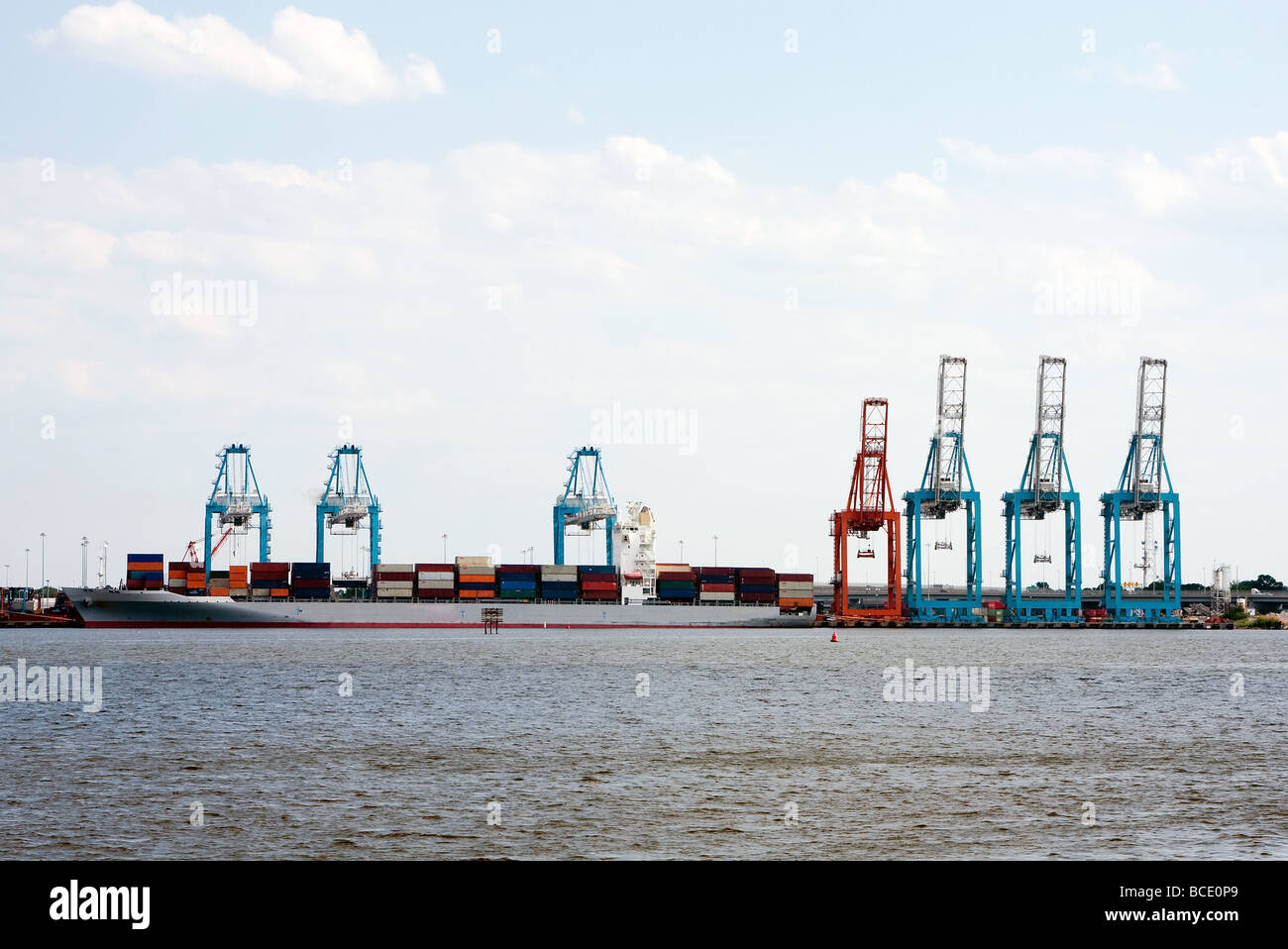 Commercial loading docks where cranes are loading containers filled ...