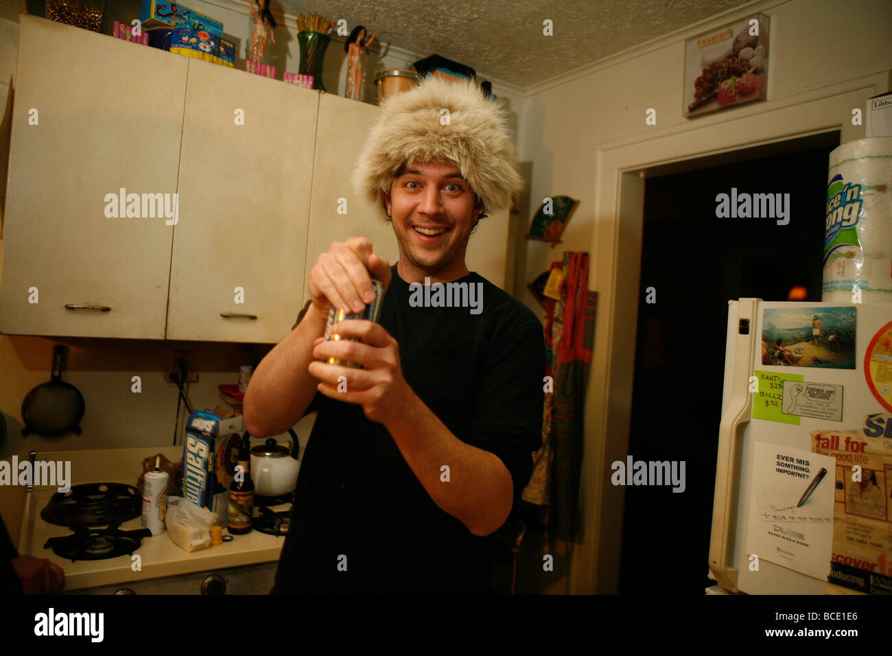 A man cracks open a beer during a winter solstice party Stock Photo - Alamy