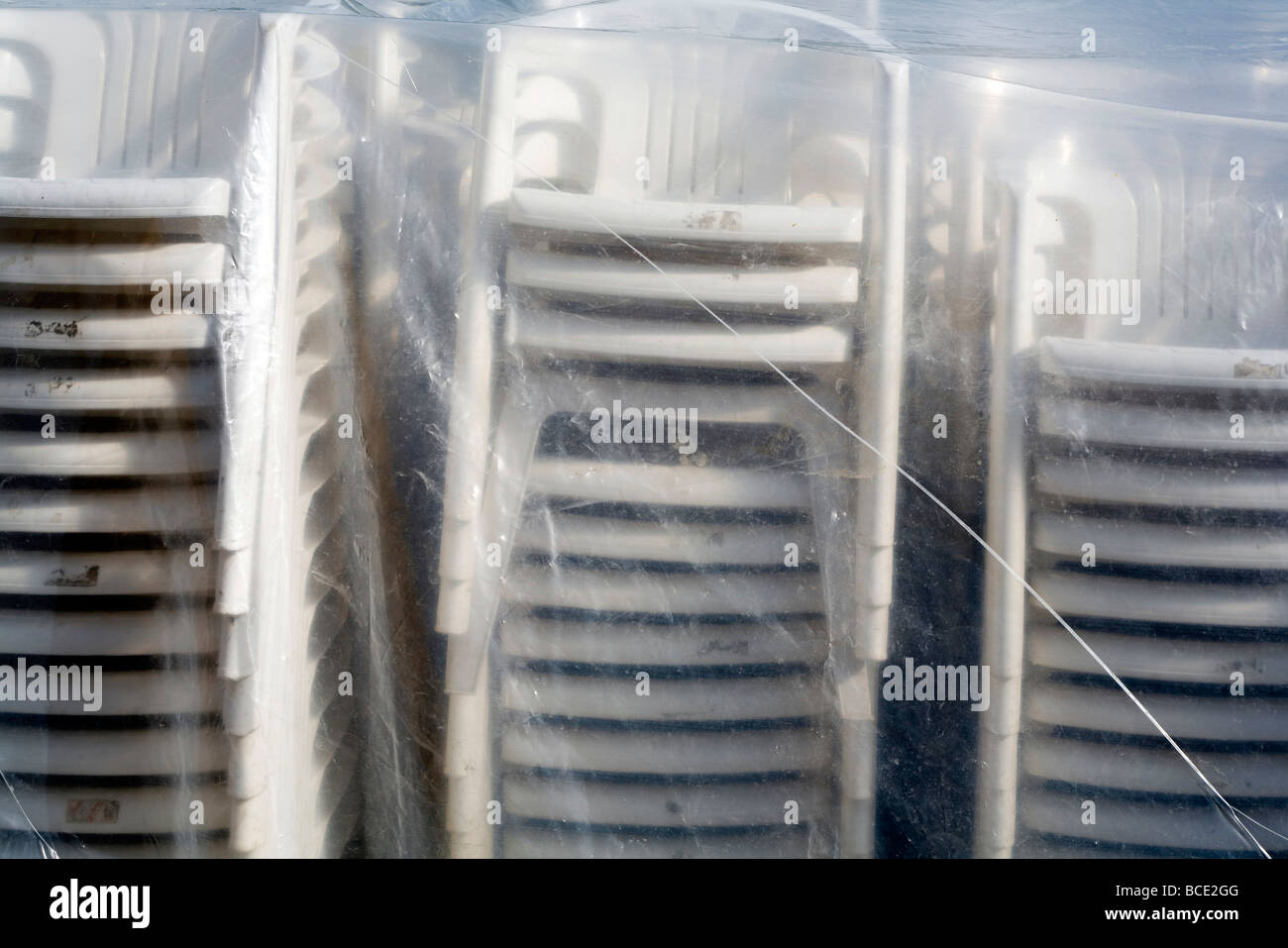 Plastic chairs covered in plastic in a park in Pec Hungary Stock Photo ...