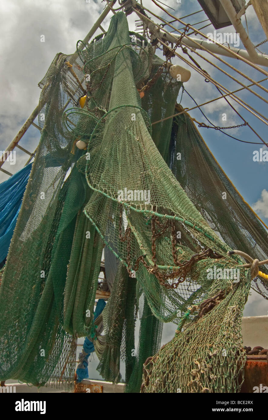 Hanging Nets. Draped fishing nets with a cloudy blue sky background ...