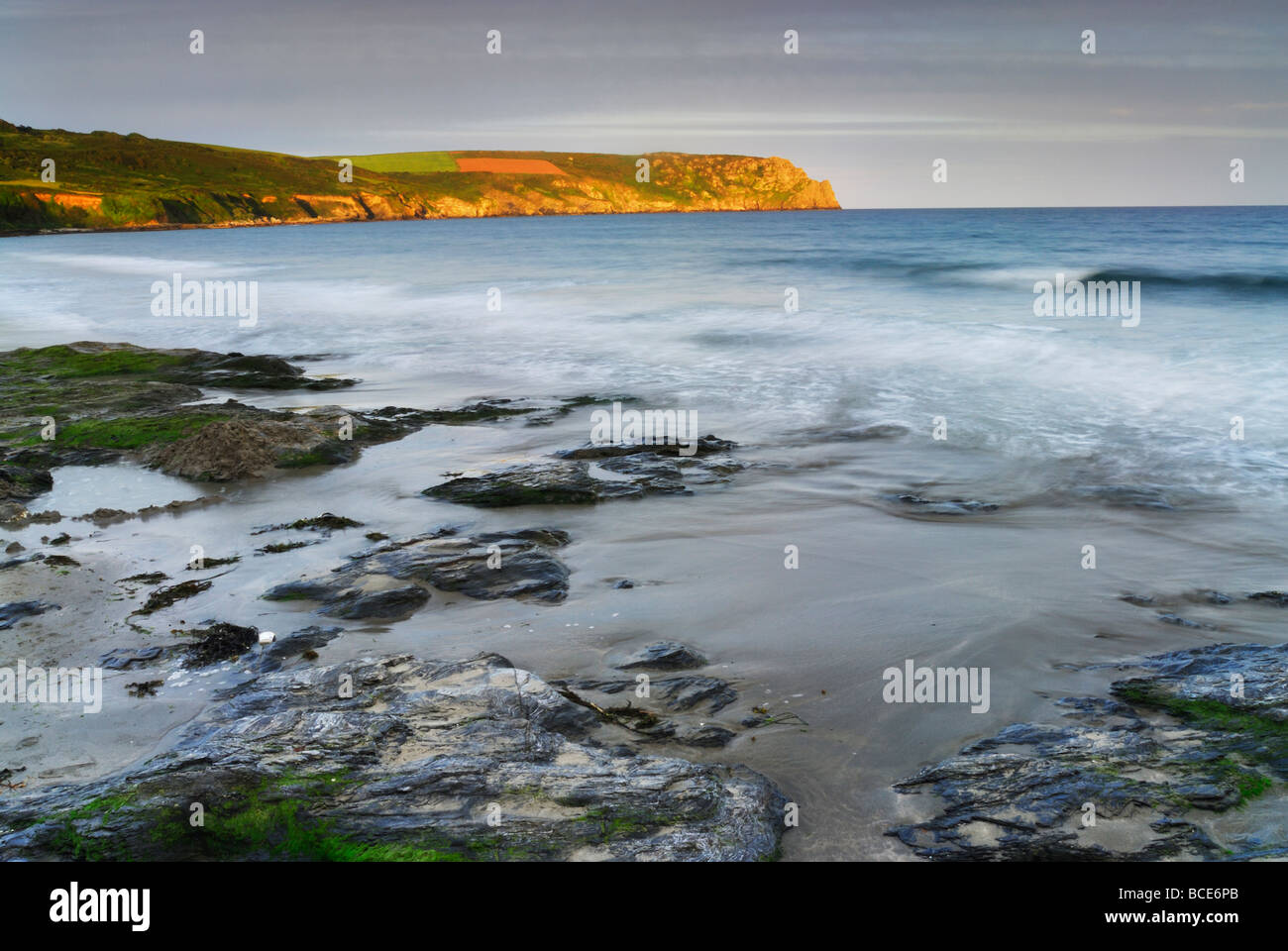 Exposed bedrock at low tide at Carne Beach Looking towards Nare Head in ...