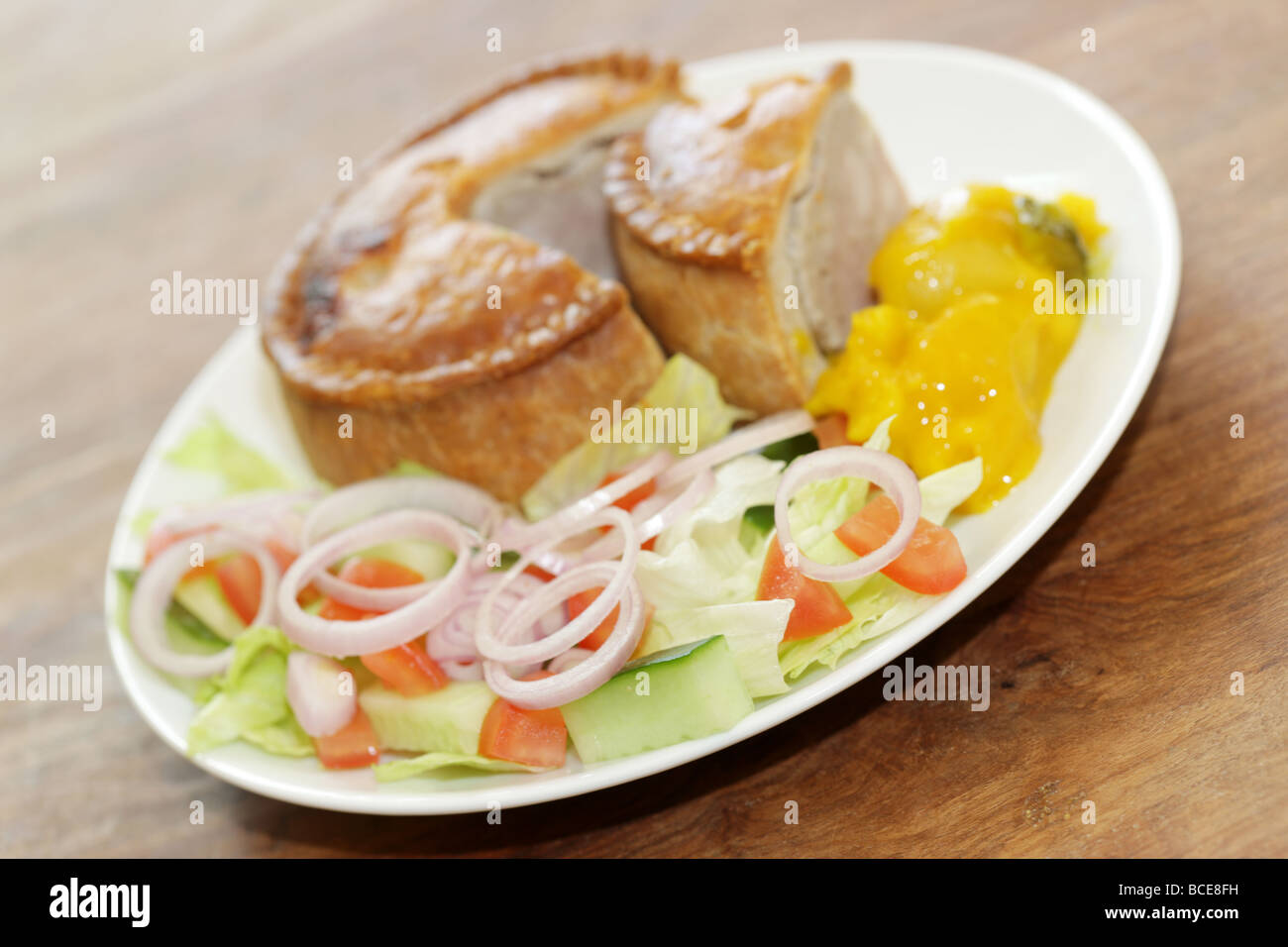 Fresh Tasty Traditional Pork Pie With A Mixed Salad And Yellow Piccalilli Pickles Meal With No ...