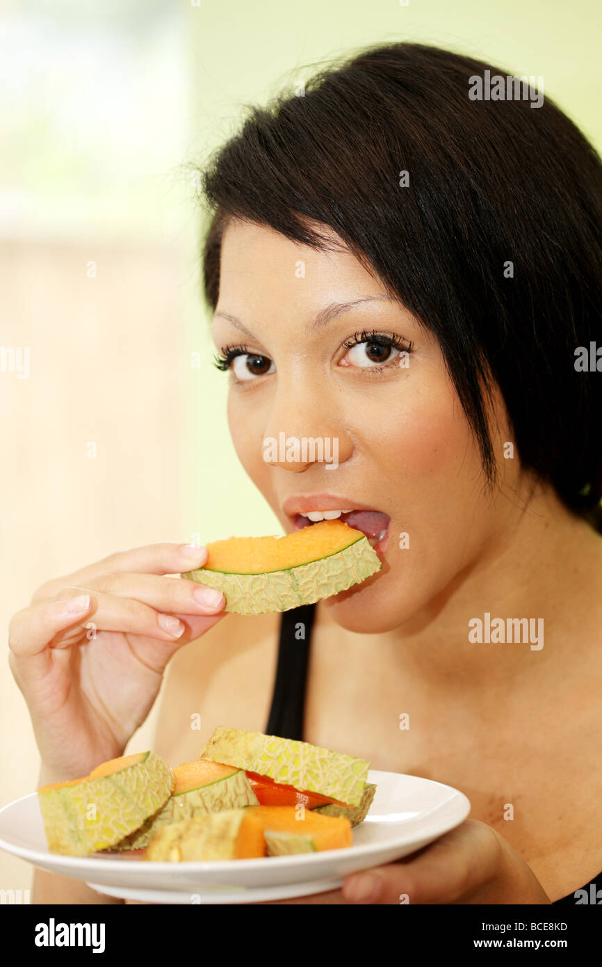 Young Woman Eating Melon Model Released Stock Photo - Alamy