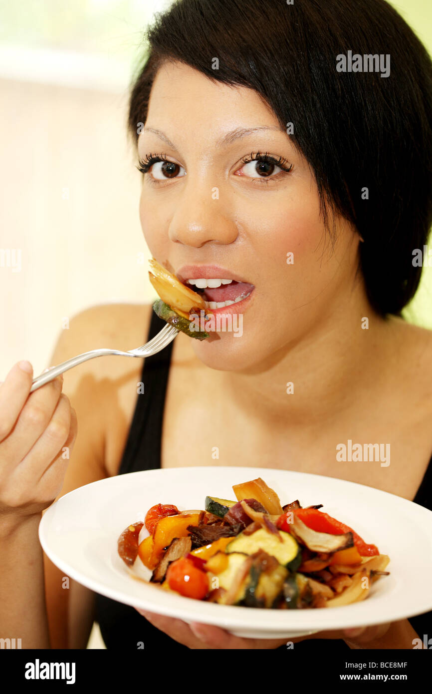 Young Woman Eating Stir Fried Vegetables Model Released Stock Photo - Alamy