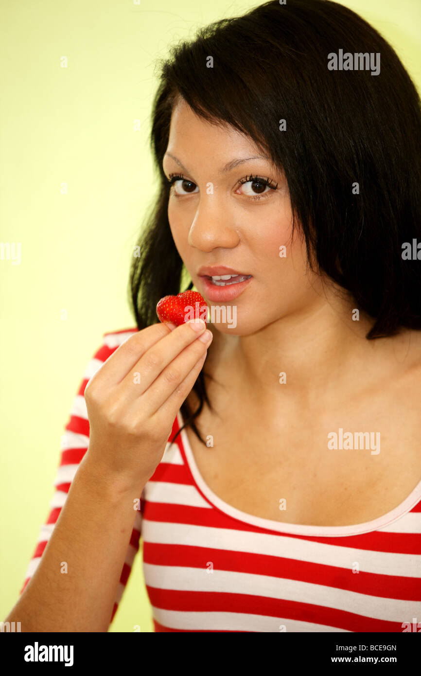 Healthy Young Woman Eating A Strawberry Model Released Stock Photo - Alamy