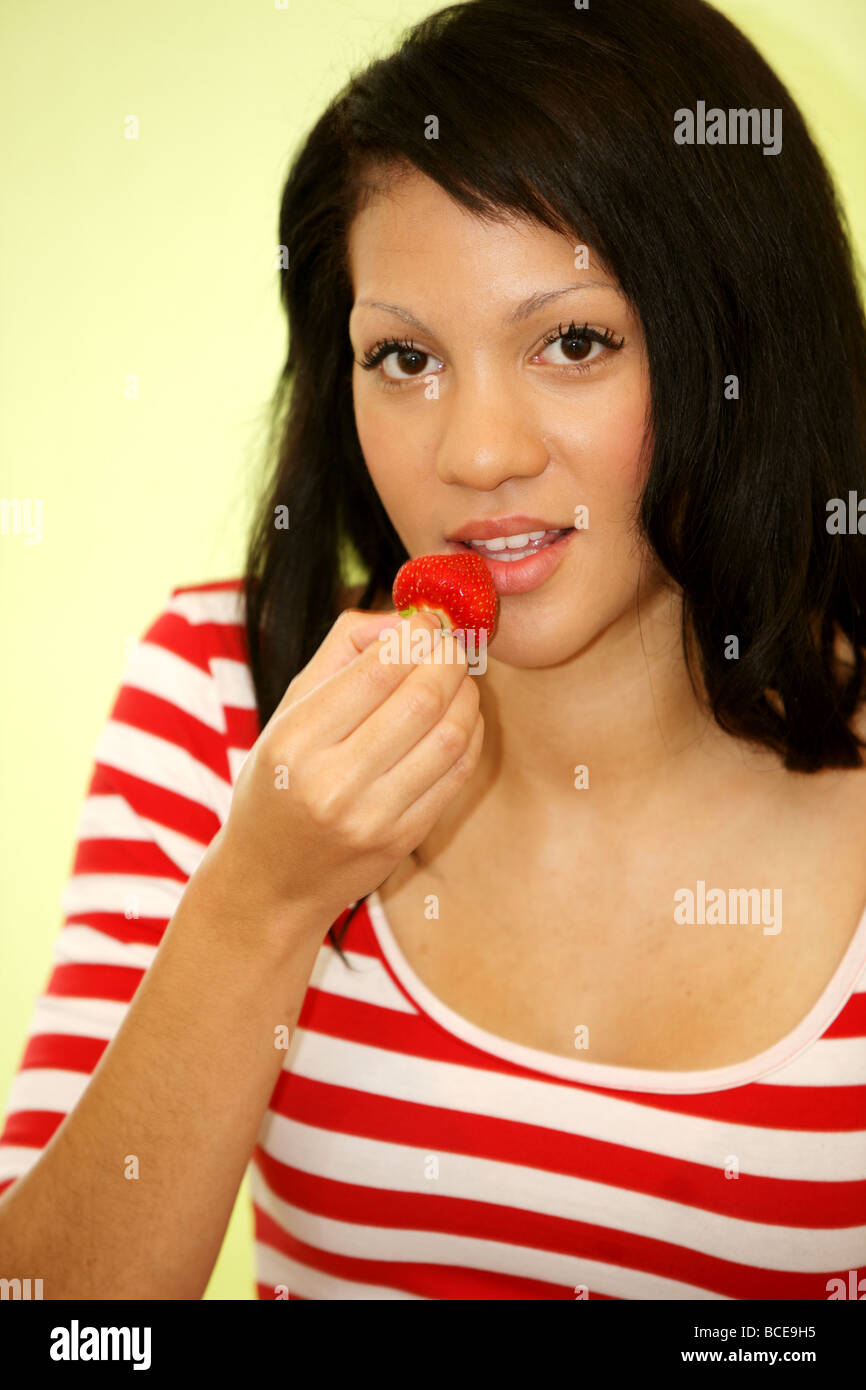 Healthy Young Woman Eating A Strawberry Model Released Stock Photo - Alamy
