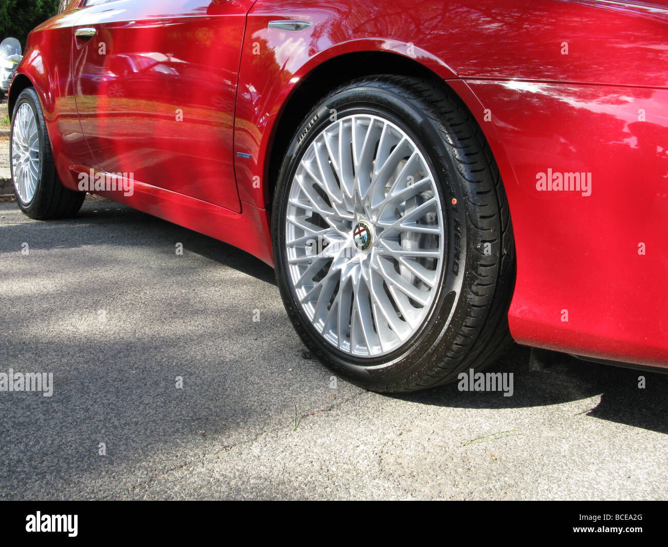 red alfa romeo sports car in street in italy Stock Photo - Alamy