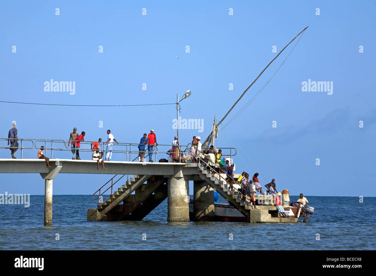 Mozambique, Inhaca Island. Local islanders carry their catch to the end ...