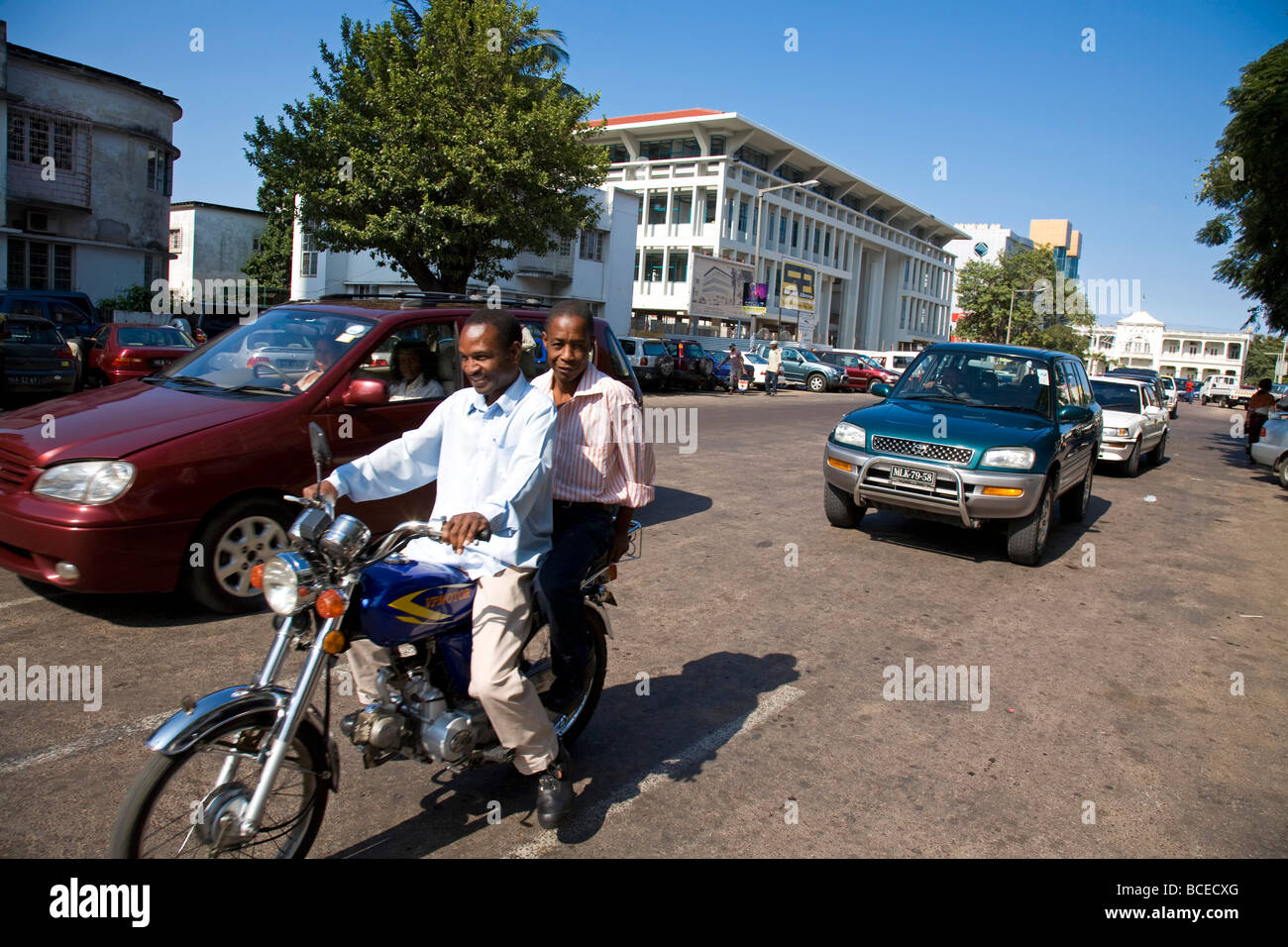 Mozambique, Maputo. Cars and a motorbike travel down Avenida S Machel ...