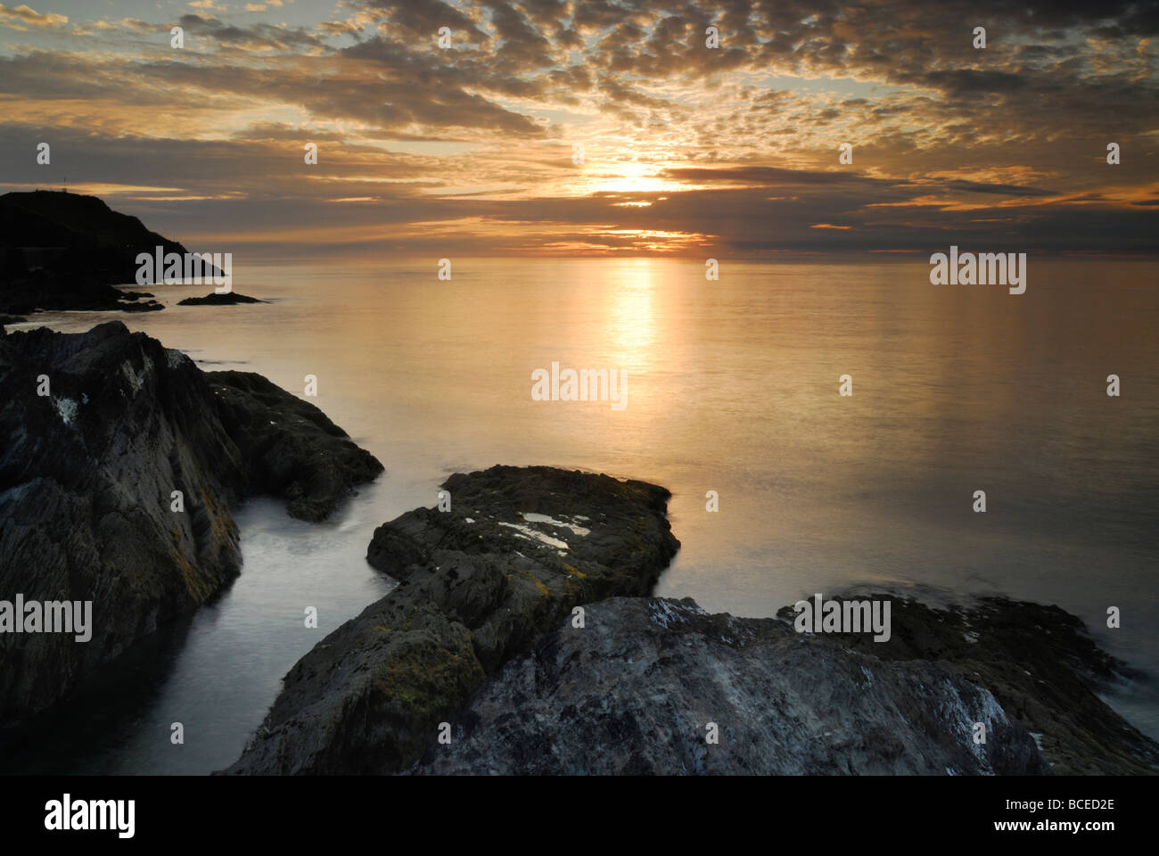 View of the setting sun at the harbour in Ilfracombe North Devon ...