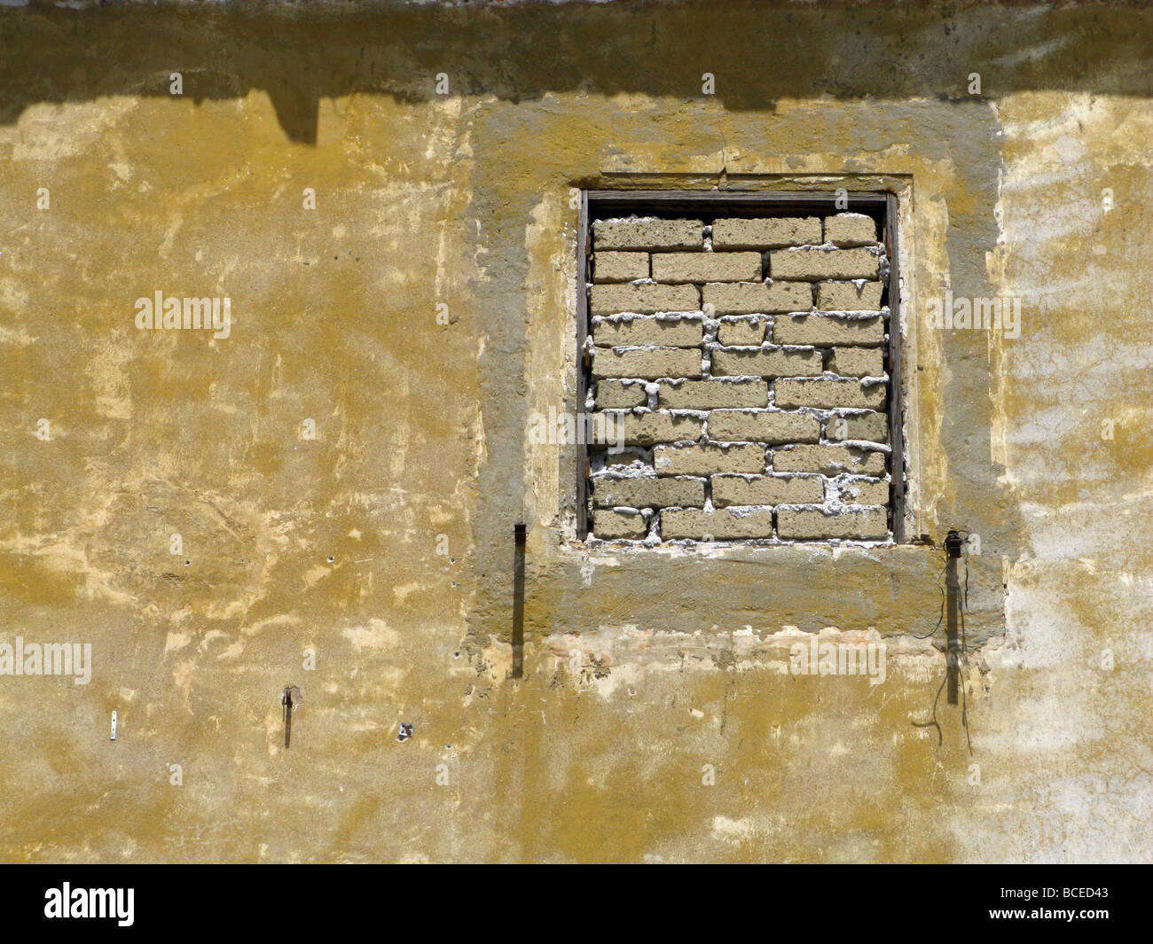 windows closed with bricks on derelict property building Stock Photo ...