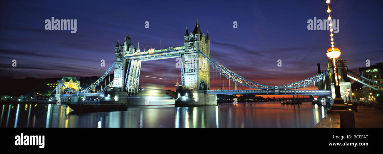 Panoramic view of Tower Bridge at sunrise with road raised, London ...