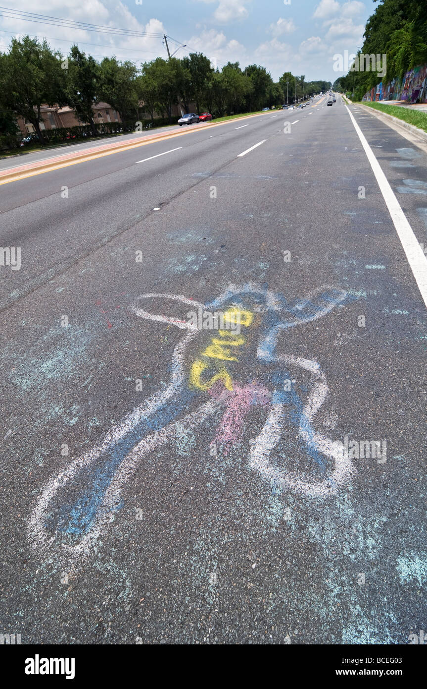 human victim figure painted on street alongside Graffiti Wall ...