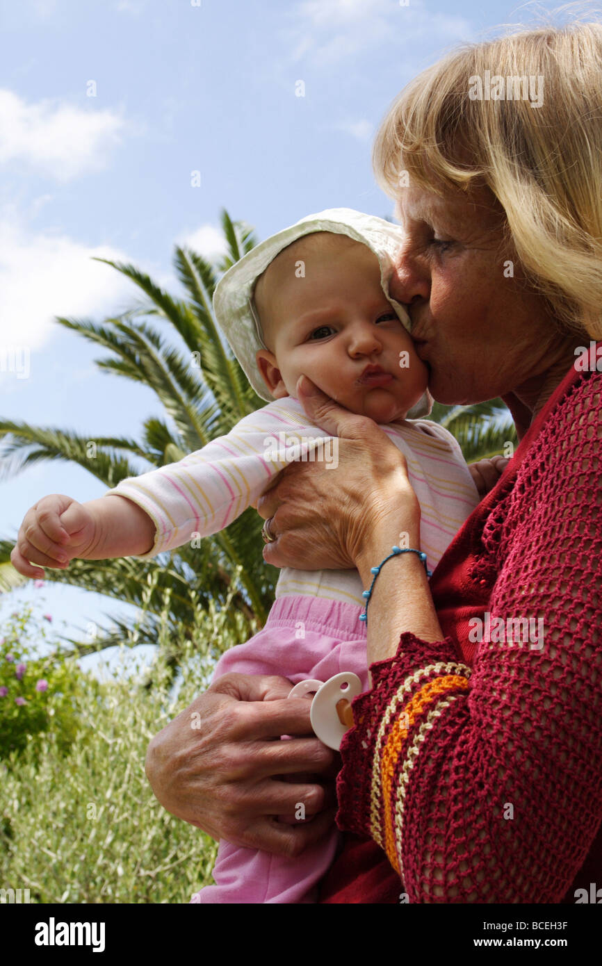 Old lady holding a baby in her arms, Conil de la Frontera, Spain Stock ...
