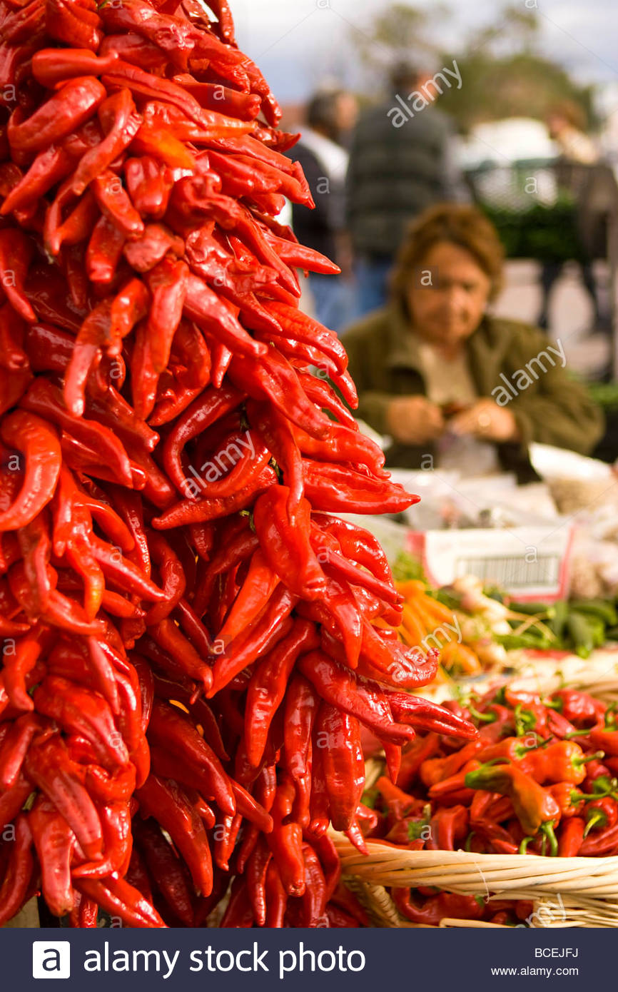 A string of dried chile peppers, or a chile ristra, hangs at a market ...
