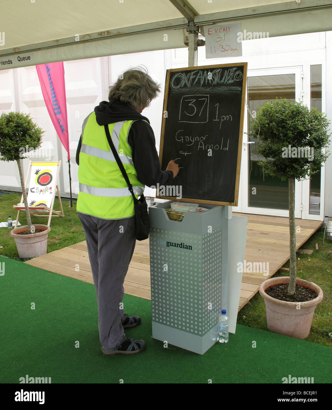 Steward official writing out the schedule on a chalkboard outside the ...
