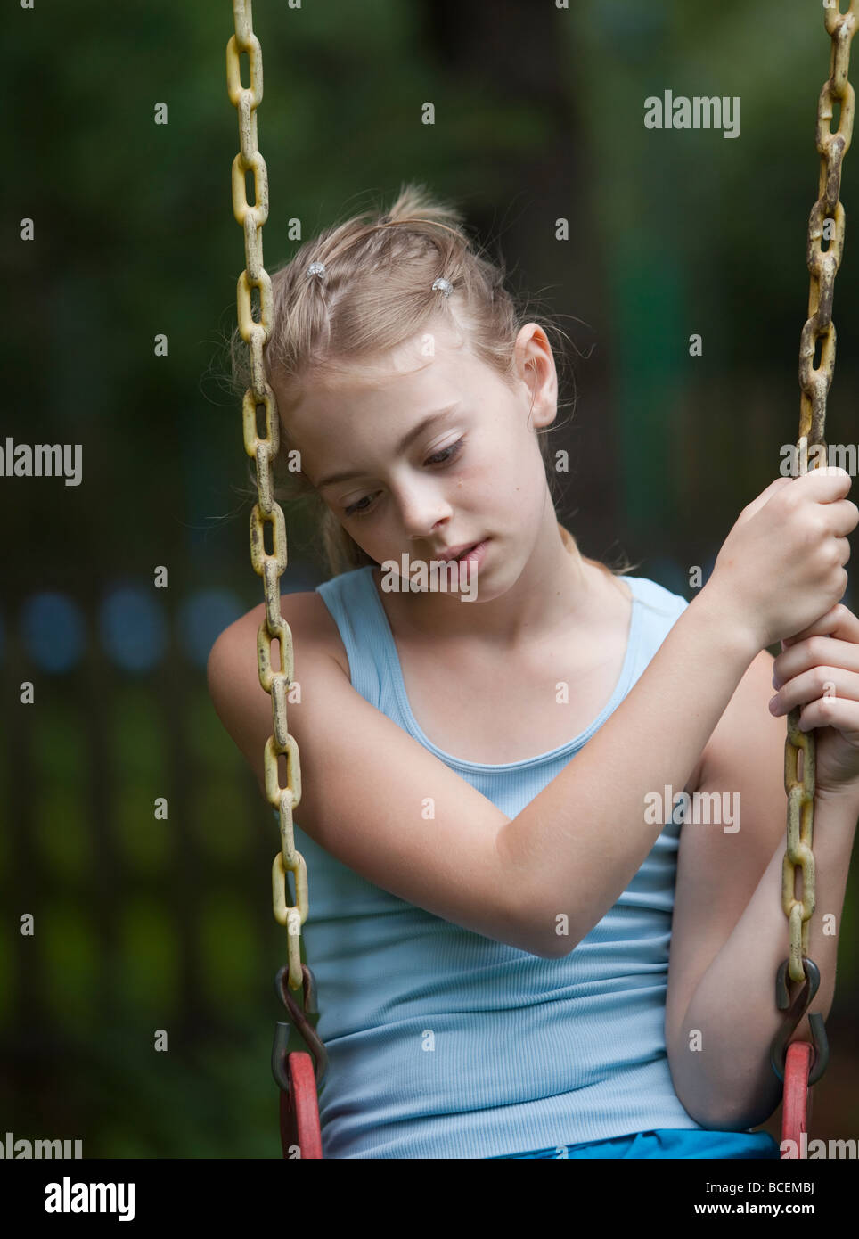 Child in a somber mood on a swing Stock Photo - Alamy
