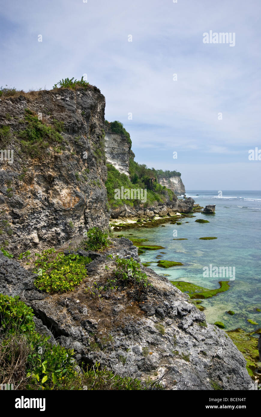 Rugged limestone cliffs overlook tranquil tropical bays and reefs Stock ...