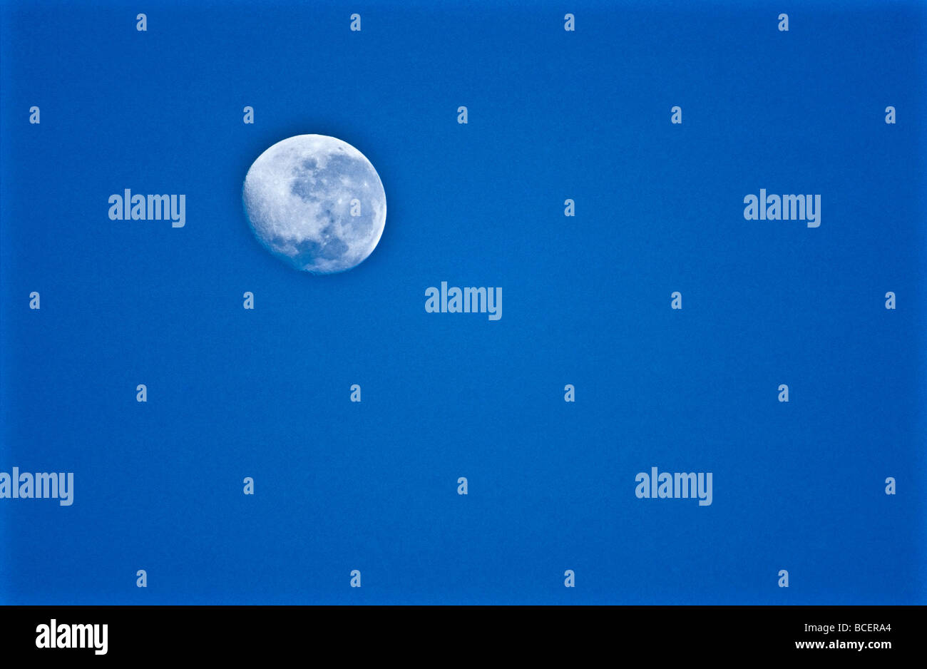 A three-quarter moon rises in the clear afternoon desert light Stock ...