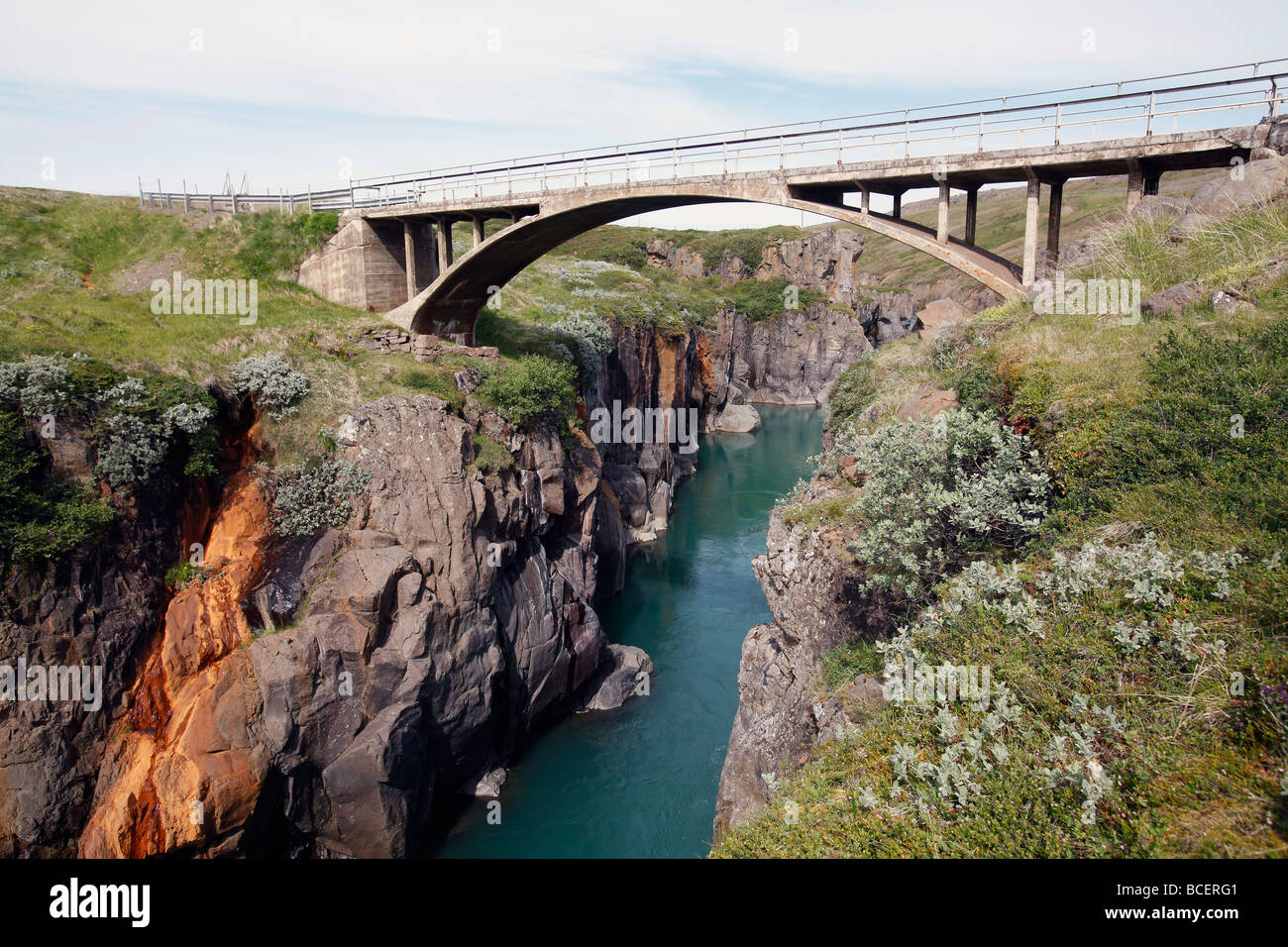 An abandoned concrete arch bridge over a gorge in northeast Iceland ...