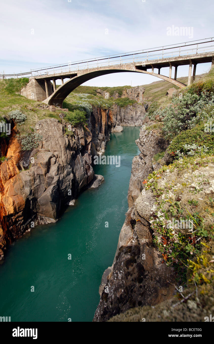 An abandoned concrete arch bridge over a gorge in northeast Iceland ...